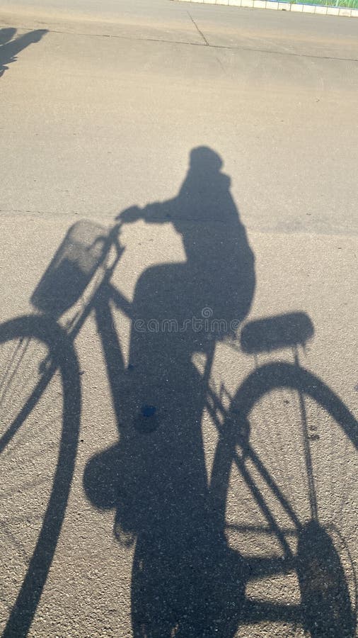 Shadow of a Bike with a Person Stock Photo - Image of people ...