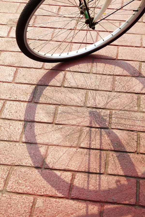 Shadow from Bike on Red Brick Road Stock Photo - Image of black, cycle ...