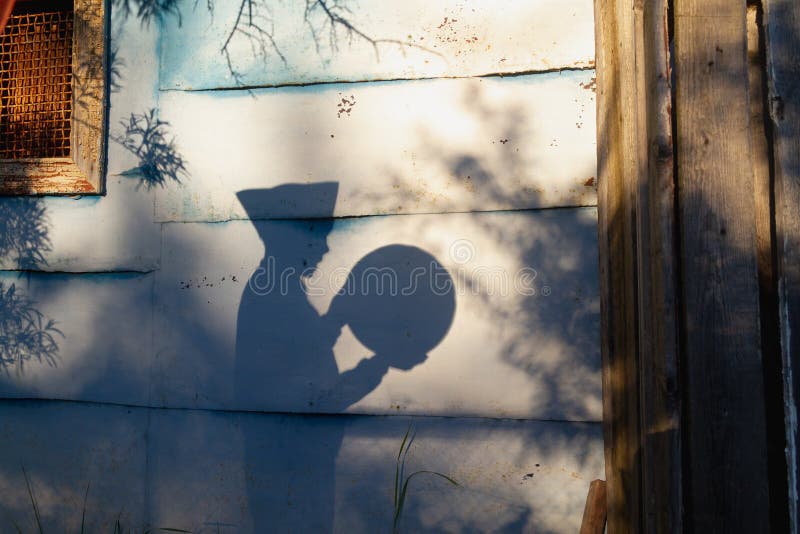 Shadow of a Boy in a Soviet Cap, a Child Holding a Round Globe Stock ...