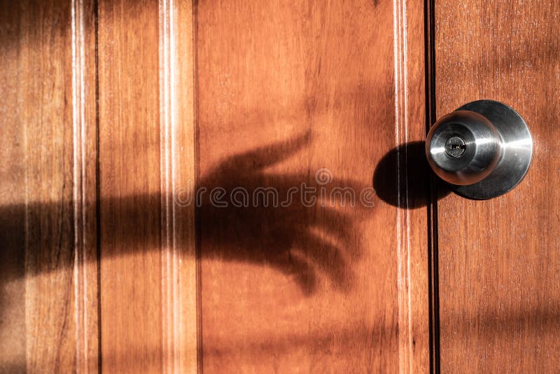 Shadow of Burglar`s Hand Trying To Open the Door Stock Photo - Image of ...