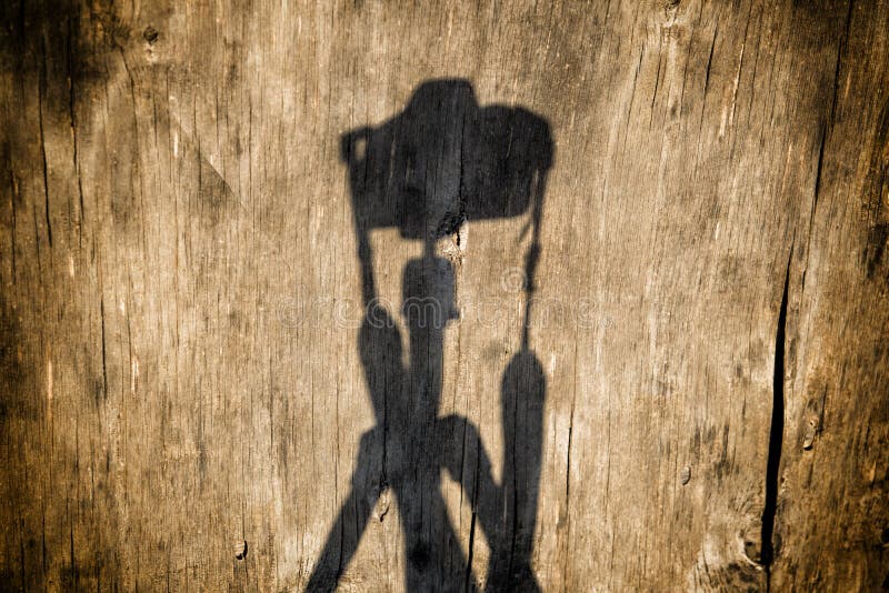 The Shadow of a Man with a Camera on the Illuminated Wall Stock Image ...