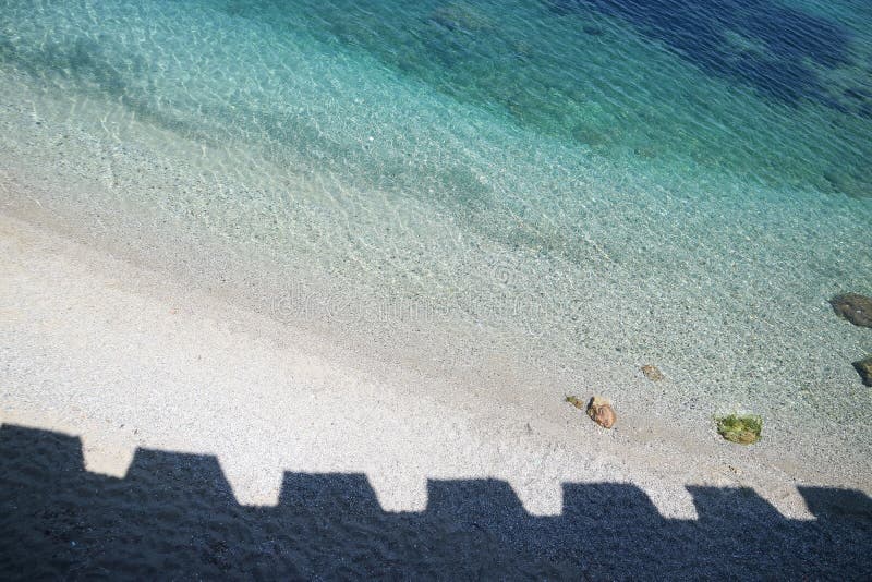 The Shadow of the Castle Walls on a White Sand Beach by the Sea. Stock ...