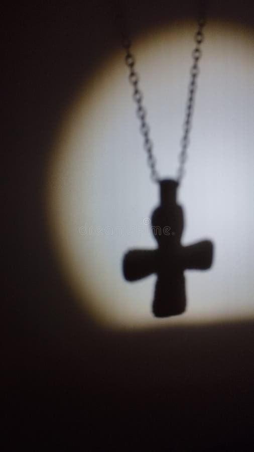 The Shadow of a Christian Cross on a Chain in the Light of a Lantern ...