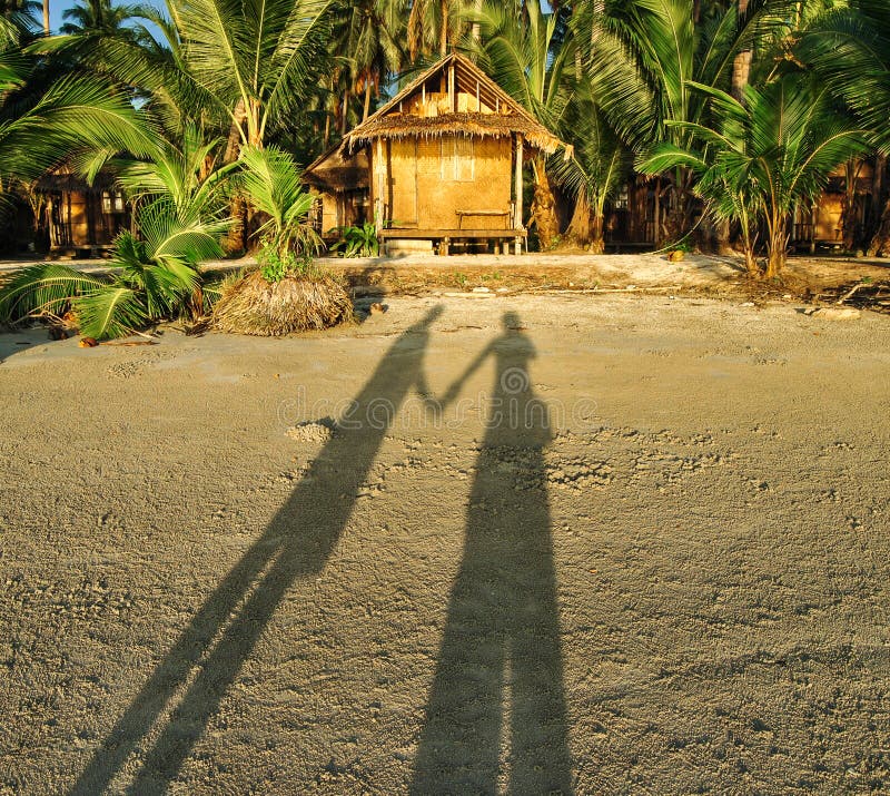 Shadow of a Couple on the Sunset Beach Near the Bungalow Stock Image ...