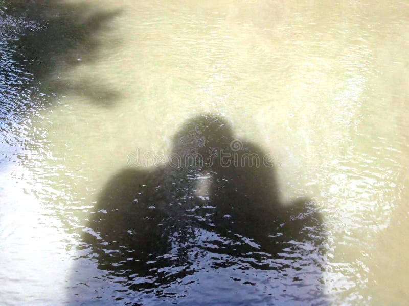 Shadow of couple on water stock image. Image of bodies, cuddle - 23831
