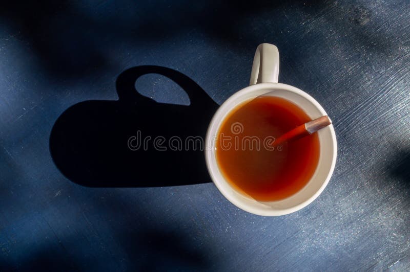 Shadow of a cup of tea stock photo. Image of brown, relaxation - 209844284