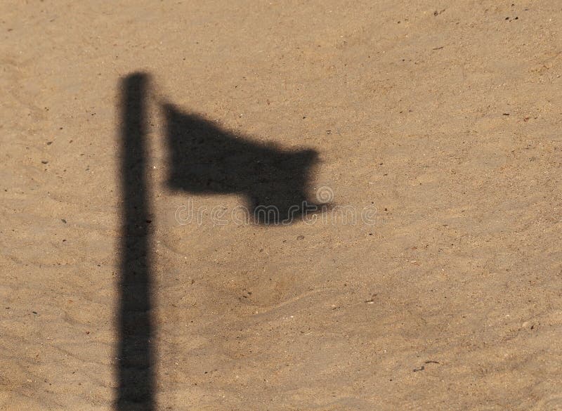 The Shadow of the Emerging Flag in the Sand Stock Image - Image of ...