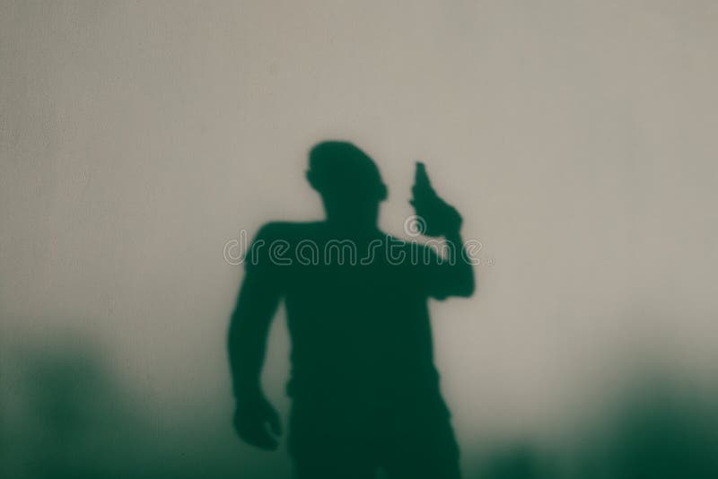 Shadow Figure. a Man Drinks Alcohol from a Bottle. Back View of Shadow ...