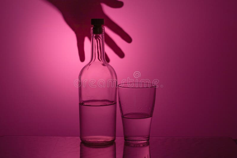 A Shadow in the Form of a Hand Reaches for a Bottle and a Glass Stock ...