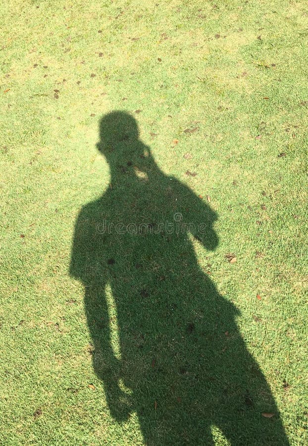 Shadow in the Form of a Human Body with Grass Texture Background Stock ...
