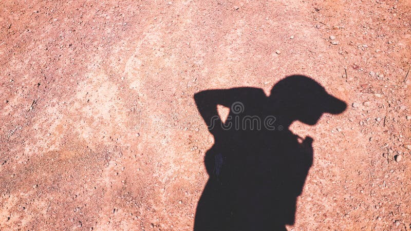 Shadow on the Ground of a Runner with a Cap in Summer with a Lot of ...