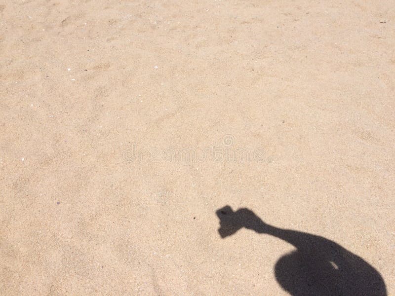 Shadow Hand Hold Camera Take a Photo on the Beach. Stock Photo - Image ...
