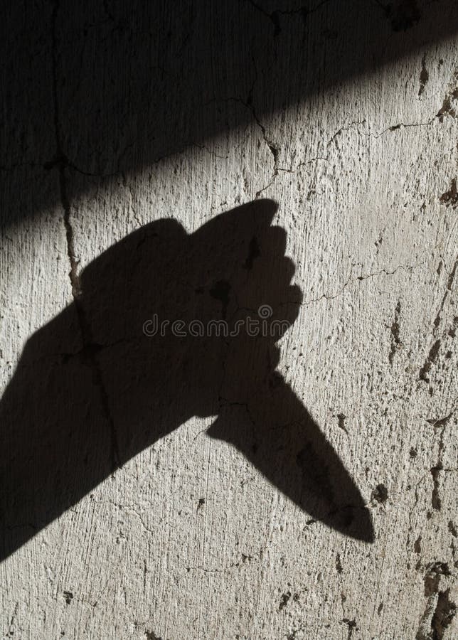 Shadow of the Hand Holding a Knife Stock Photo - Image of aggression ...