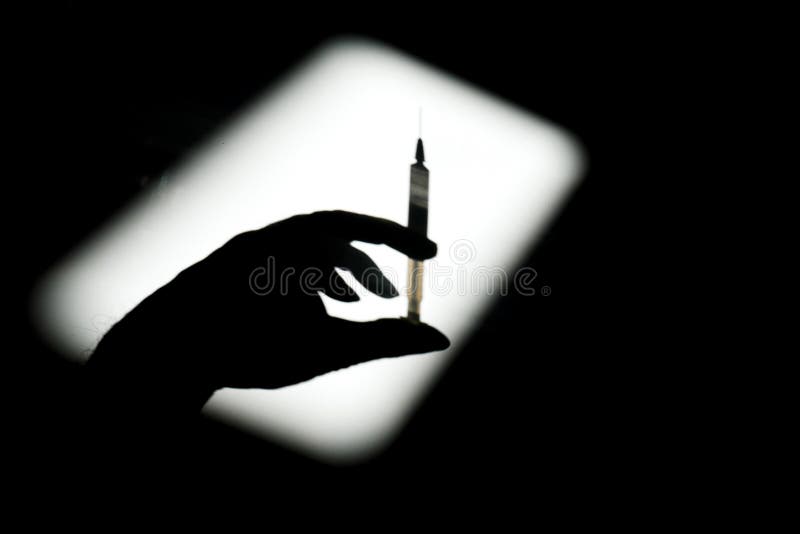 Shadow of a Hand Holding a Syringe Stock Photo - Image of injecting ...