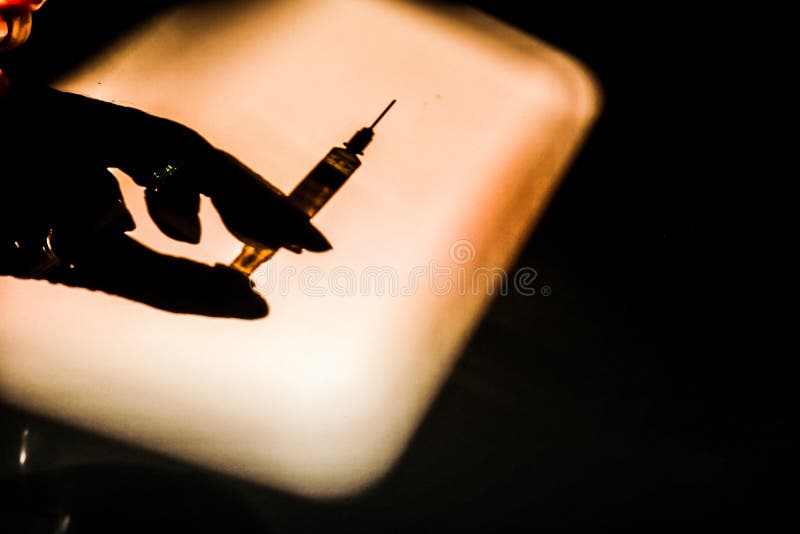 Shadow of a Hand Holding a Syringe Stock Photo - Image of injecting ...
