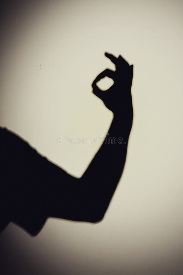 Shadow of a Hand from the Night Light of a Flashlight on a White Wall ...