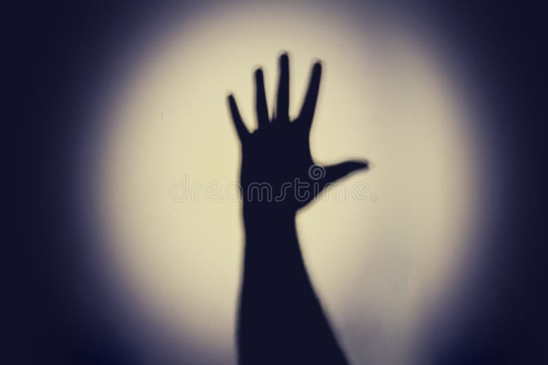 Shadow of a Hand from the Night Light of a Flashlight on a White Wall ...