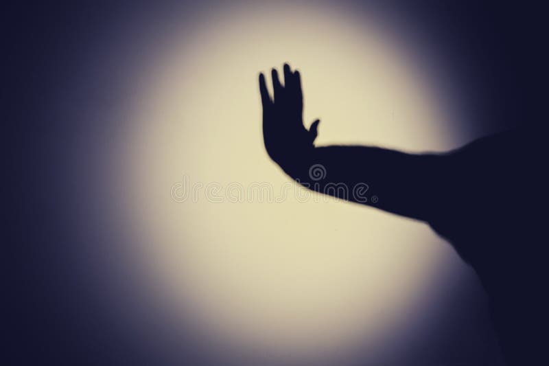 Shadow of a Hand from the Night Light of a Flashlight on a White Wall ...