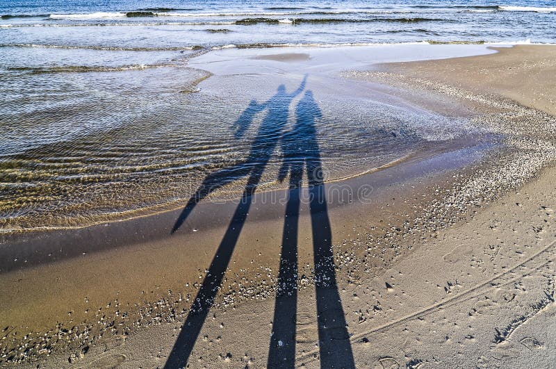Shadow of Happy People Walking on a Beach by the Baltic Sea. Stock ...