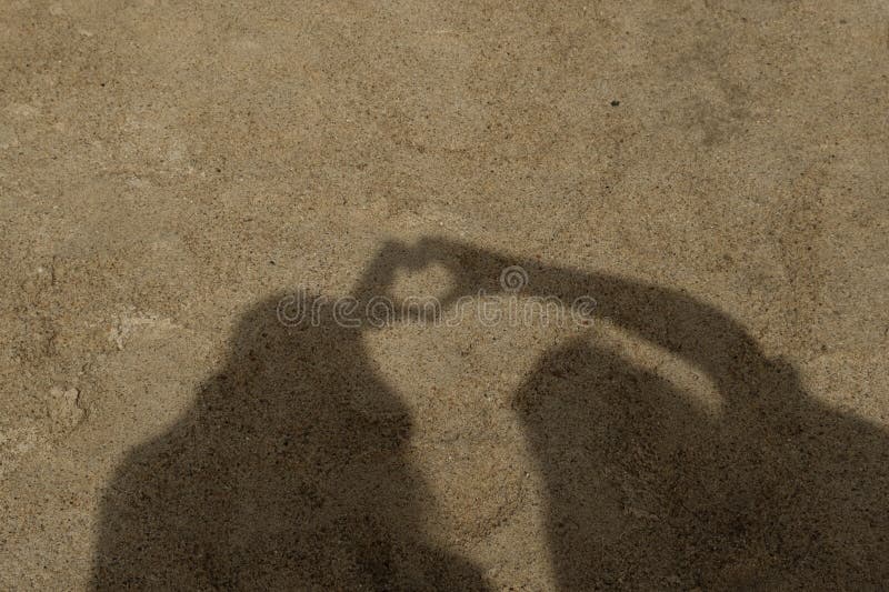 Shadow Heart Formed by Hands on a Sun Sand Stock Photo - Image of ...
