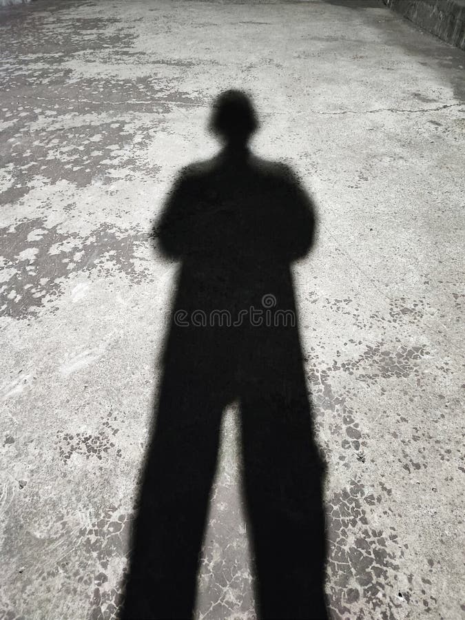 The Shadow of a Human Figure Standing Upright Stock Image - Image of ...