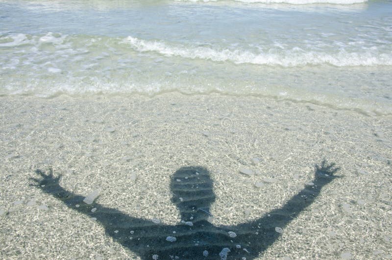 Shadow man on beach stock photo. Image of ocean, couple - 57205584