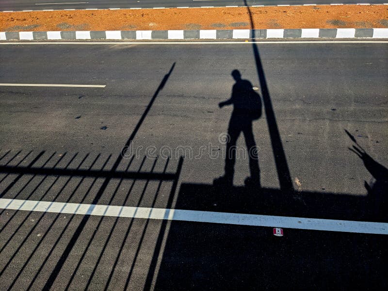 The Shadow of a Man Going on a Asphalt Road Stock Photo - Image of ...