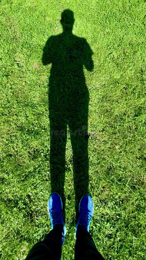 The Shadow of a Man on the Green Gras Stock Image - Image of gras ...