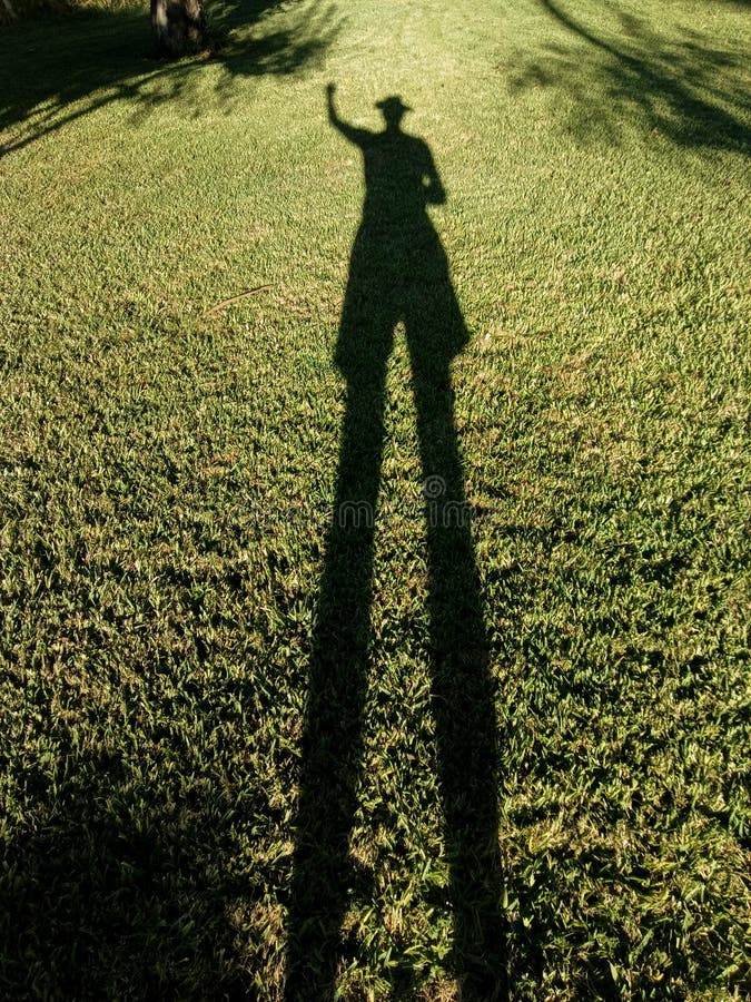 Shadow of man at sunset stock photo. Image of summer - 255301012