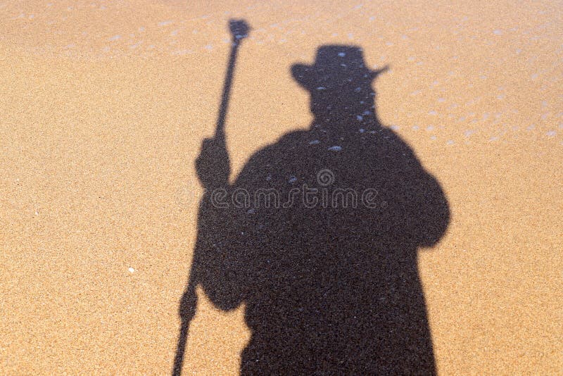 Shadow of a man by the sea stock photo. Image of wave - 204348698