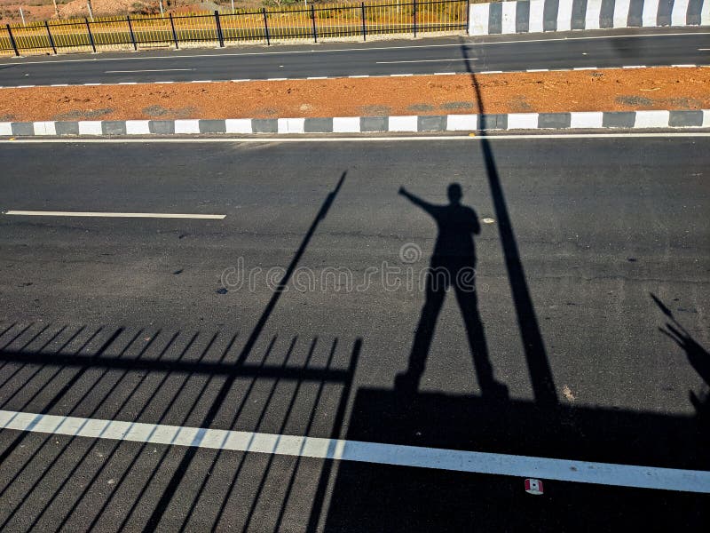 The Shadow of a Man Showing Route on a Road Stock Image - Image of ...
