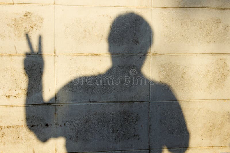 Shadow of Man Showing Two Fingers on the Wall, a Sign of Peace or ...