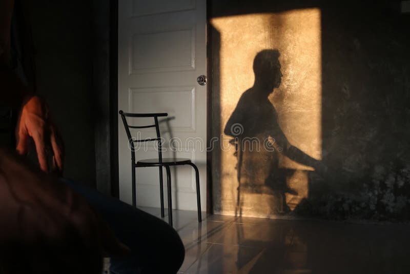 The Shadow of a Man Sitting in a Chair on the Wall Stock Photo - Image ...