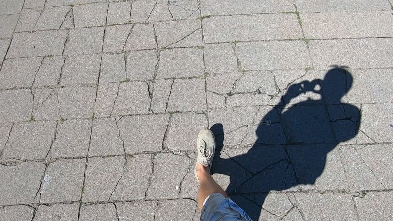 The Shadow of a Man Walking on the Sidewalk Stock Video - Video of ...