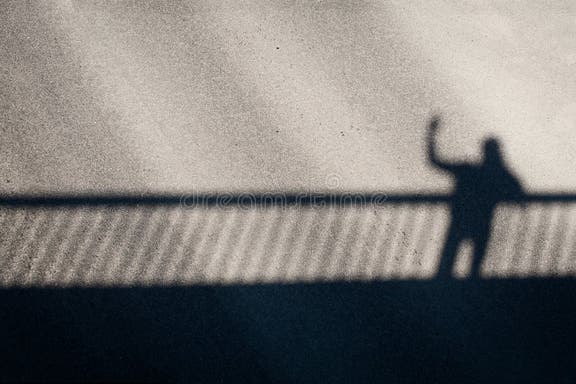 Shadow of a Man Waving from a Bridge Stock Photo - Image of asphalt ...