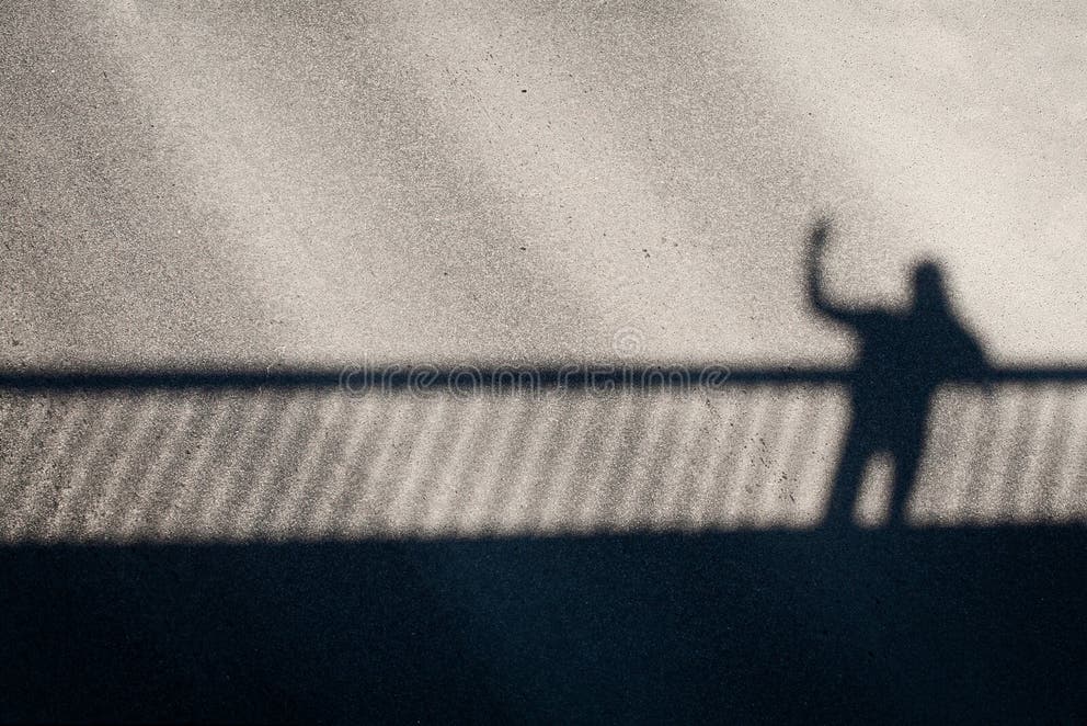 Shadow of a Man Waving from a Bridge Stock Photo - Image of asphalt ...
