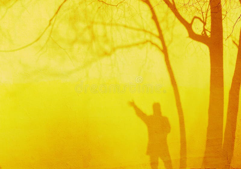 Shadow of a Man Waving and Trees Against a Yellow Wall in the Evening ...