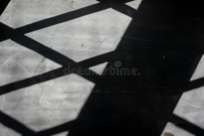 The Shadow of the Metal Grill on the Dark Window Sill. Stock Image ...