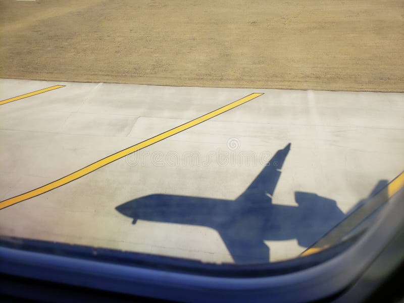Shadow of a Passenger Jet Landing on a Runway Stock Photo - Image of ...