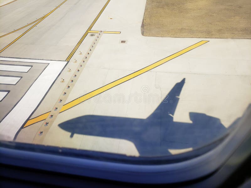 Shadow of a Passenger Jet Landing on a Runway Stock Image - Image of ...