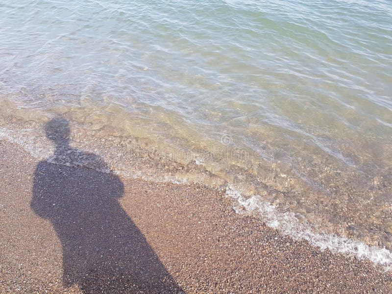Shadow of a Person Casted on the Beach and Tide Stock Photo - Image of ...