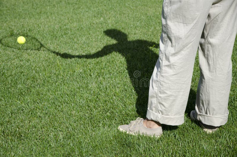 Shadow of a Person Playing Tennis on the Green Grass Stock Photo ...