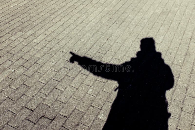 Shadow of a Person Standing on the Ground Pointing at a Particular ...