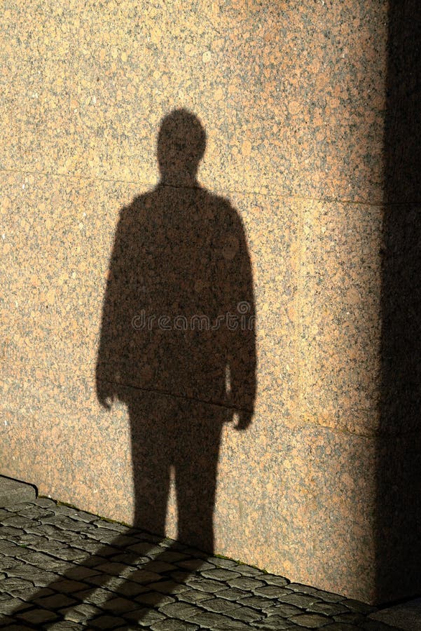 Shadow of a Person Standing on the Ground Pointing at a Particular ...