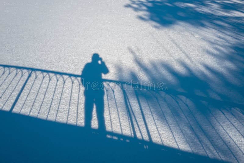 Shadow of a Photographer Shooting with a Camera on the Background of ...