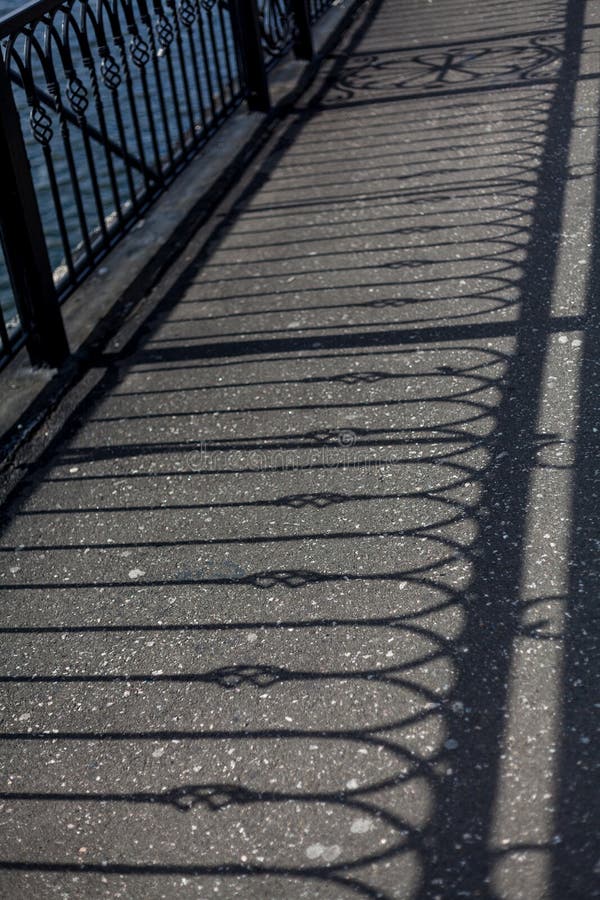 Shadow of Railing Designs on Asphalt Stock Photo - Image of forged ...