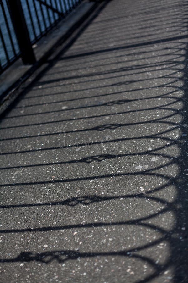 Shadow of Railing Designs on Asphalt Stock Photo - Image of outdoors ...