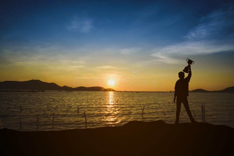 The Shadow of the Silhouetted Man is Happy and Holds the Trophy in the ...
