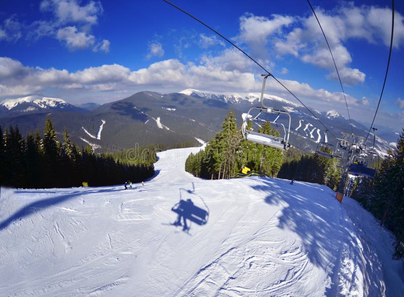 Skier Skiing Downhill In High Mountains Against Sunset Stock Photo ...