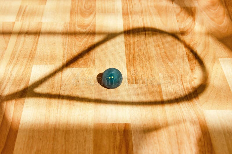 Shadow of Squash Racket with Ball Lying on it. Squash Ball Lies on ...